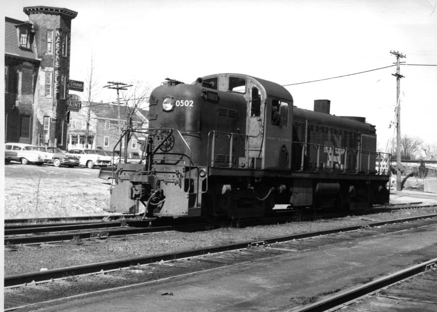 Engineer's side view of DERS-2b #0502 (RS-2) in Taunton, in front of Mason's Supply | NHRHTA Archive